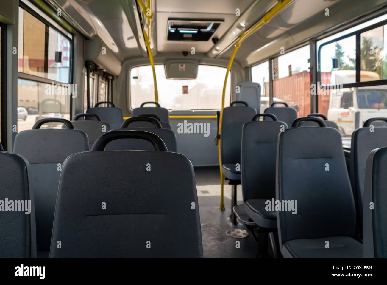 Leatherette seats in the empty cabin of a city public municipal bus ...