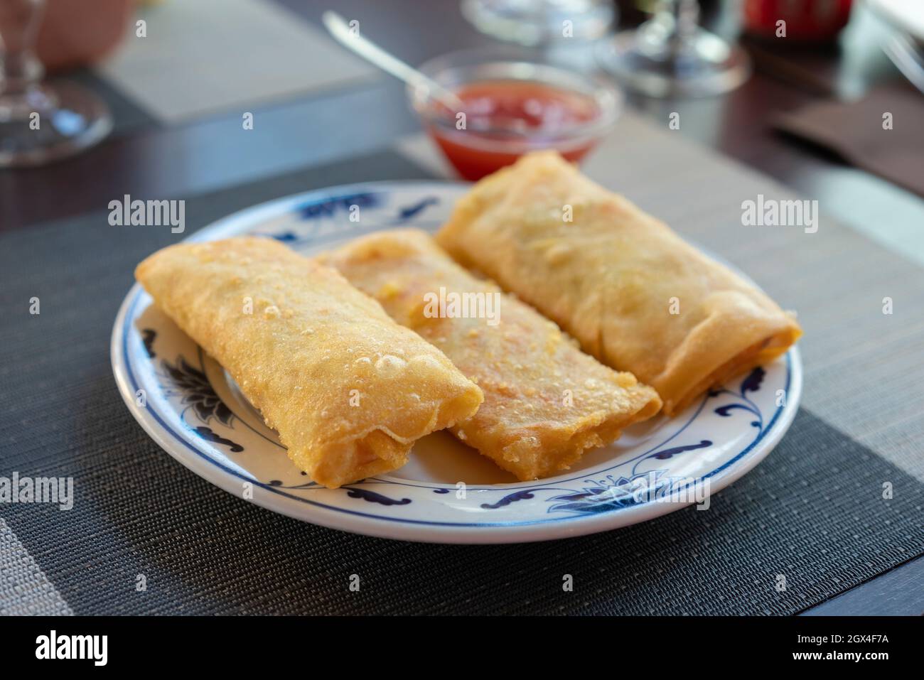 Traditional spring rolls fried on white plate at restaurant.background ...