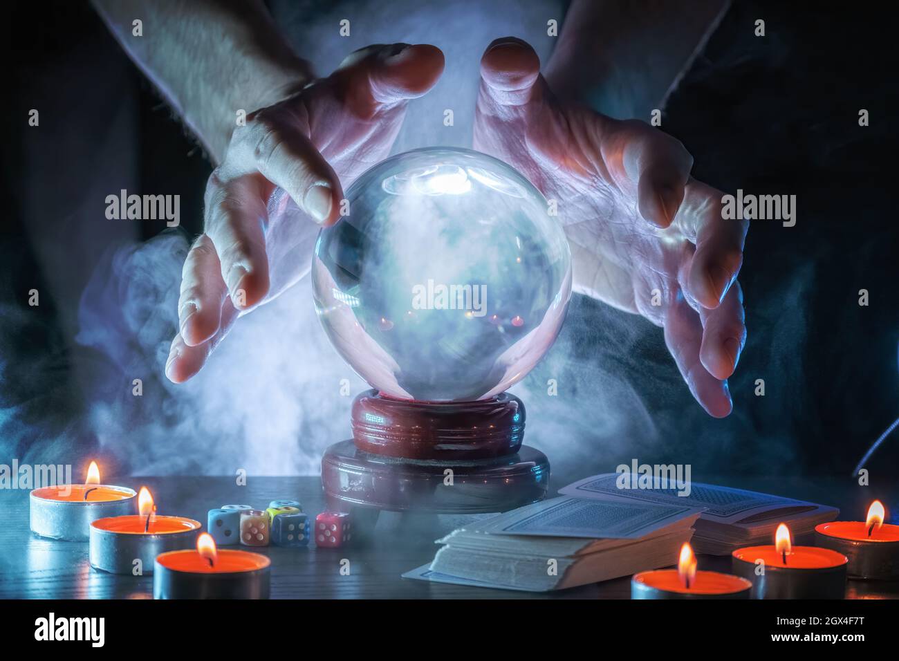 Magician or fortune teller is predicting future with crystal sphere ...