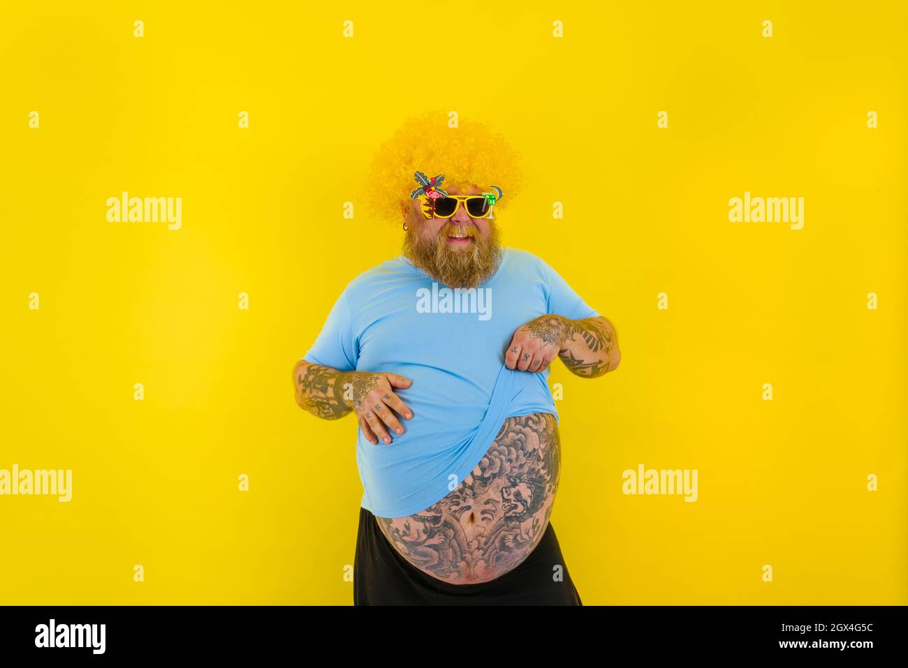 Fat man with wig in head and sunglasses shows off her big belly Stock ...