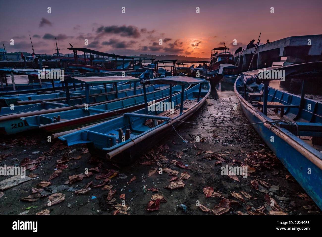 beautiful sunset view on the beach with fishing boats and pier Stock ...
