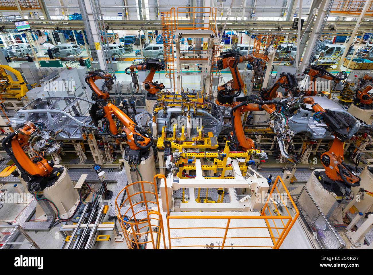 assembly line in a car factory, welding with robots, automated work ...