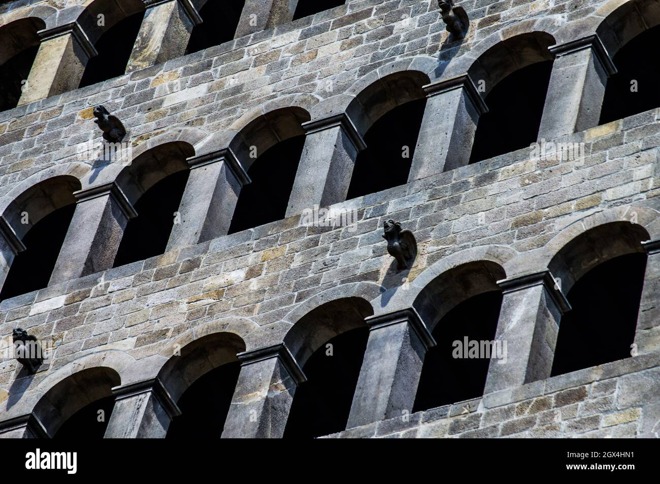 Gray stone building wall with arches Stock Photo - Alamy