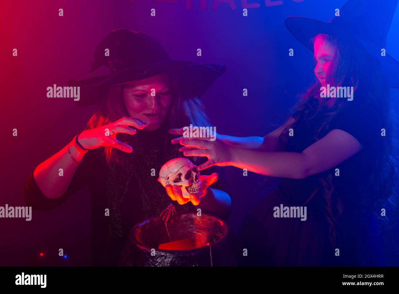 Two halloween witches making a potion and conjure in halloween night ...