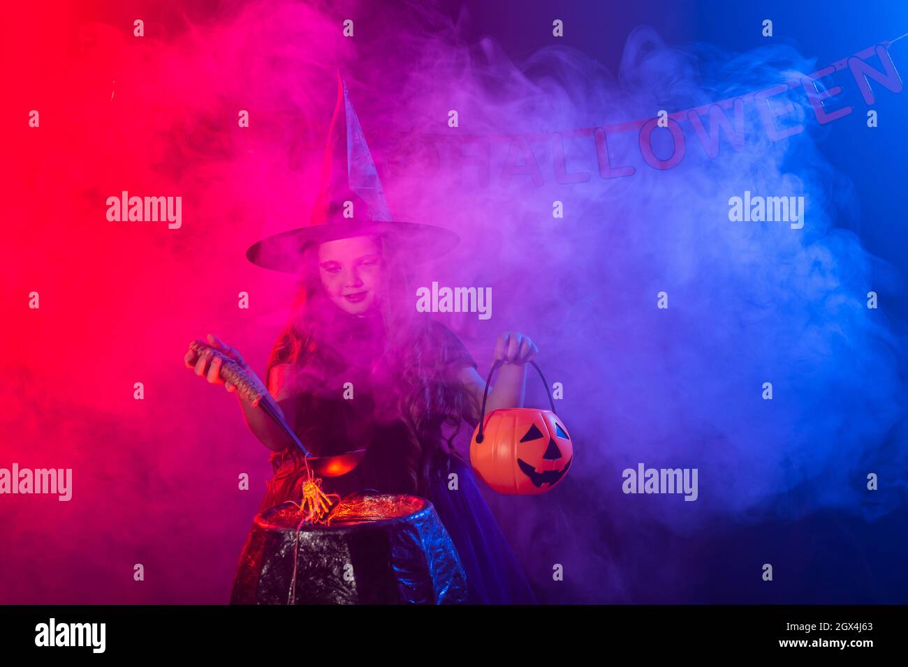 Little witch child cooking potion in the cauldron on Halloween Stock ...