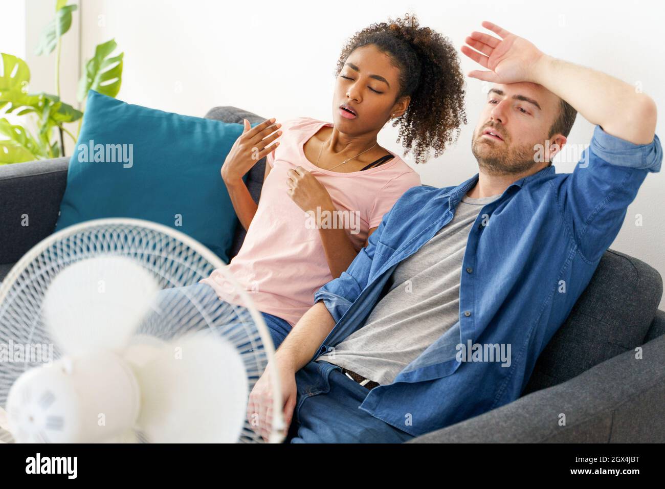 Mixed race couple trying to relief from summer heat wave Stock Photo ...