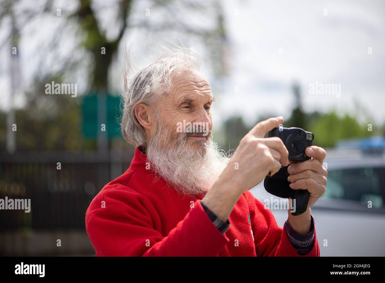Close-up face portrait of bearded senior man photographer with old ...