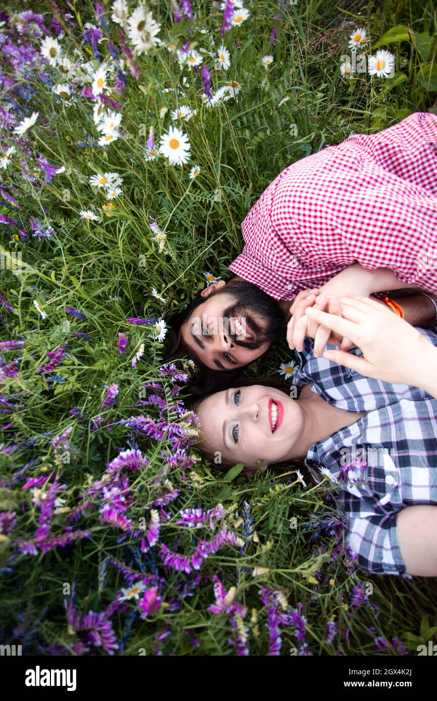 Romantic couple love moment in field among wild flowers Stock Photo - Alamy