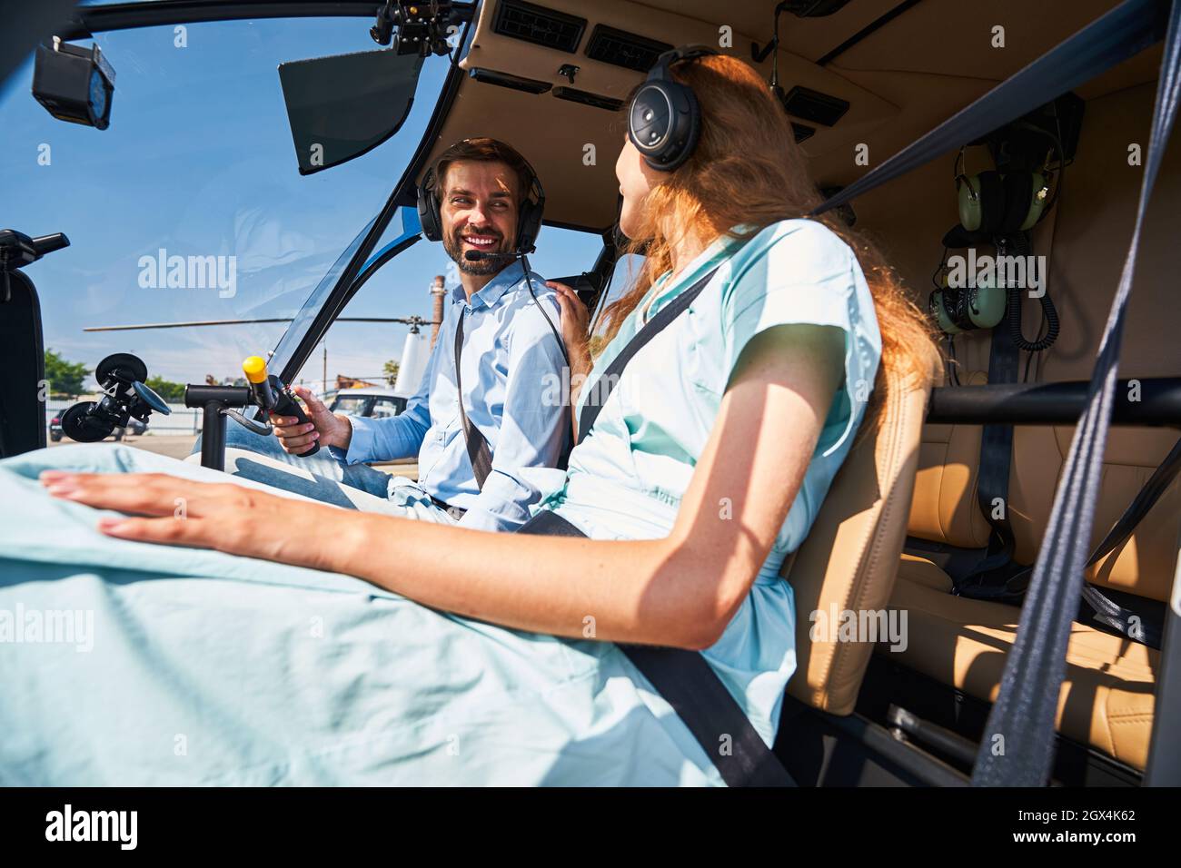 Happy airman smiling at female passenger before take-off Stock Photo ...