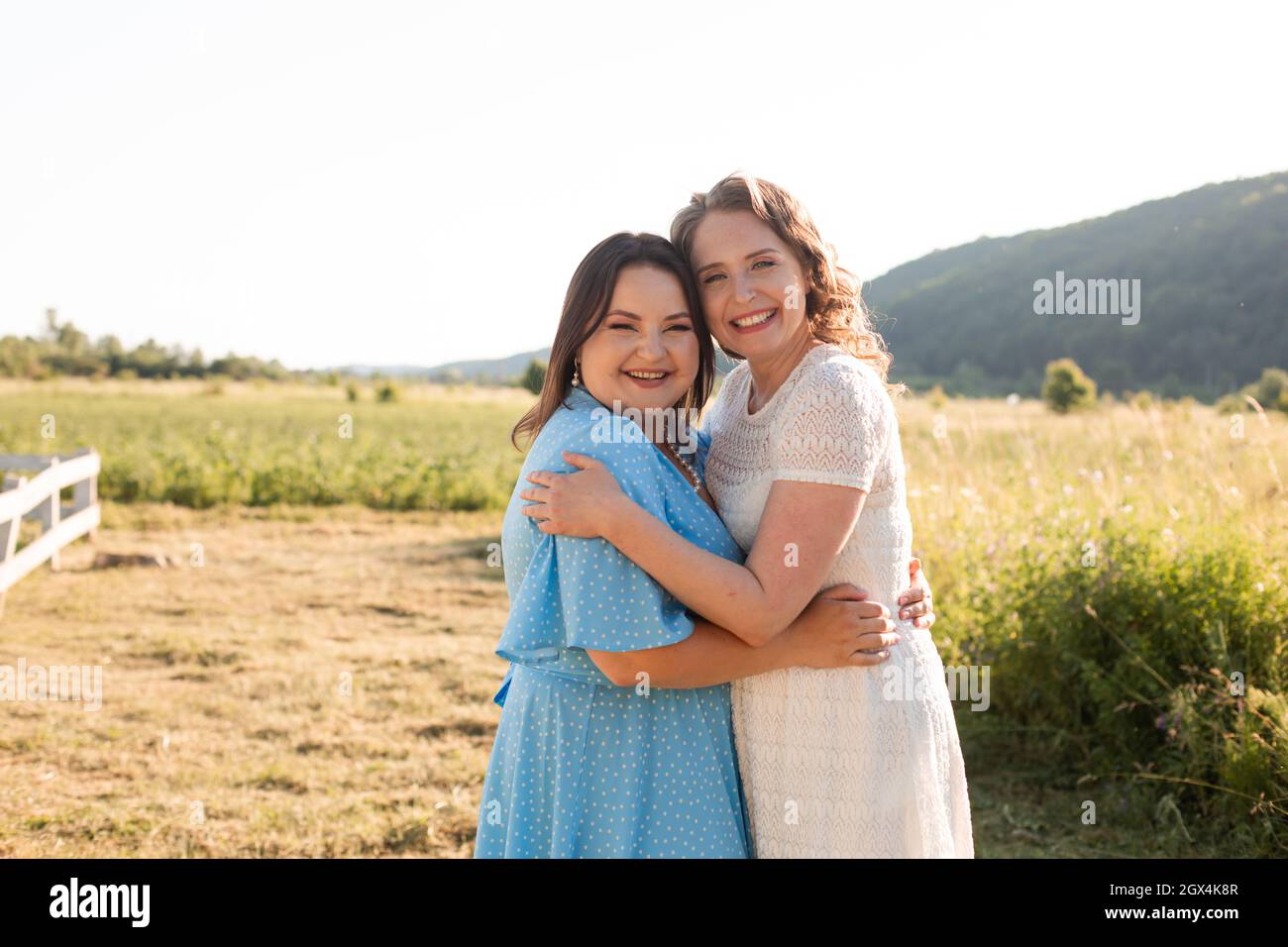 Two sisters hugging each other at the farm Stock Photo - Alamy