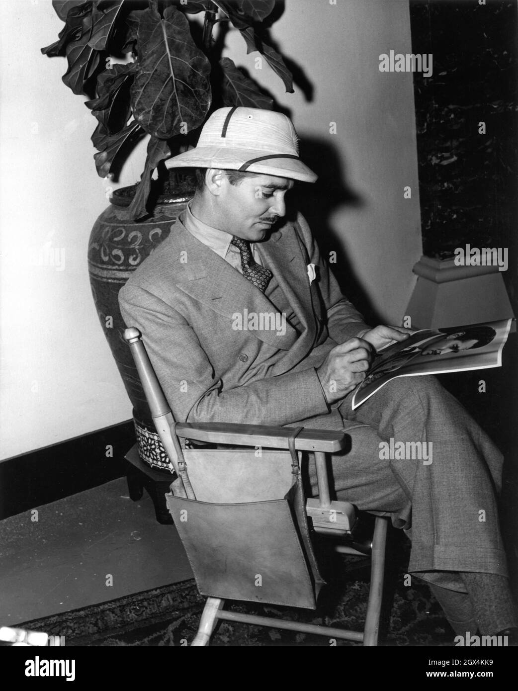 CLARK GABLE signs a large format photo of himself on set candid during ...