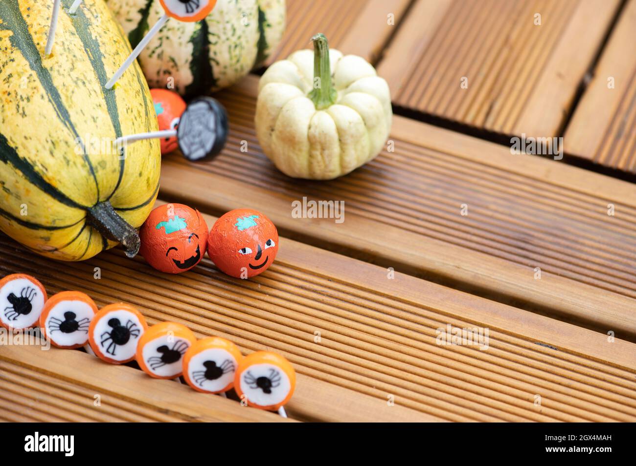 Halloween decorations background with pumpkins and sweets candies on ...