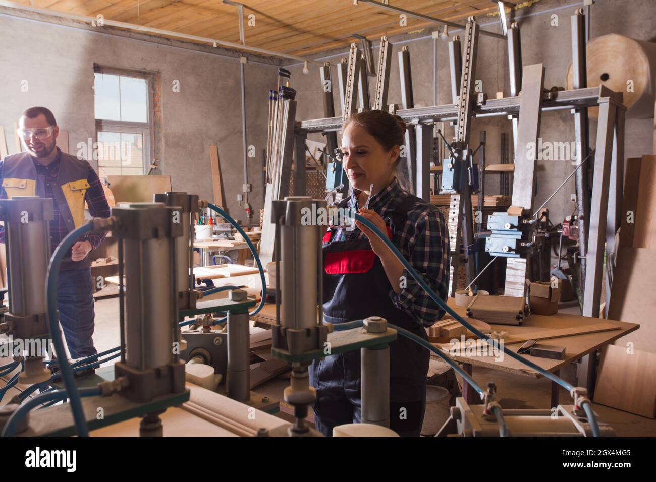 Cheerful female production operator in blue coverall Stock Photo - Alamy
