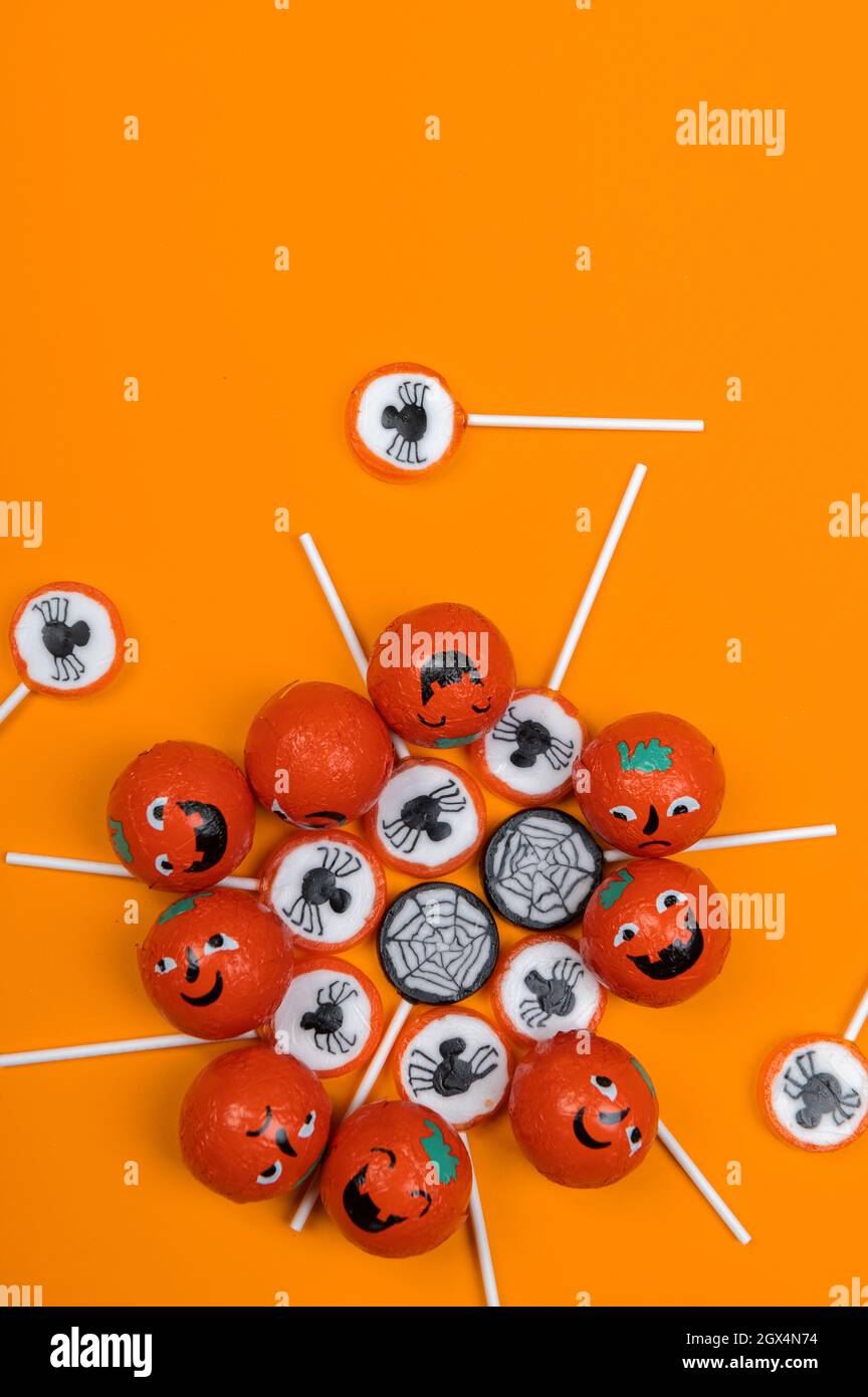 Halloween candy with black spiders,cobweb,smiling and angry pumkins on ...