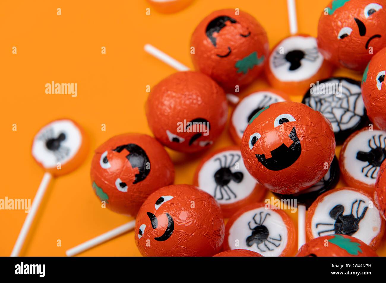 Halloween candy with black spiders,cobweb,smiling and angry pumkins on ...