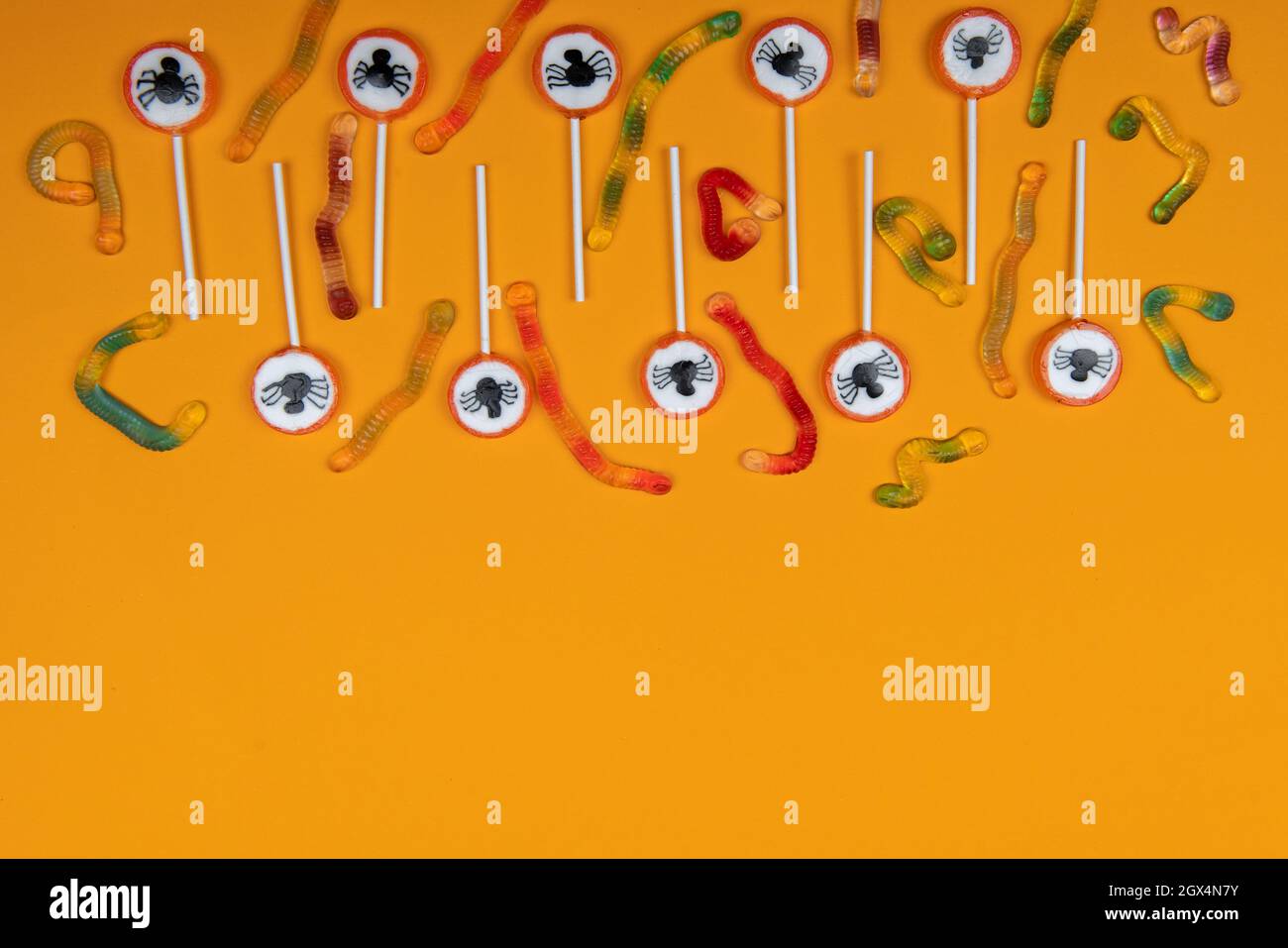 Halloween candy with black spiders,cobweb and tasty jelly worms on ...