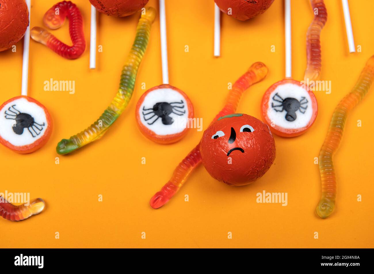 Halloween candy with black spiders,cobweb,pumpkin and tasty jelly worms ...