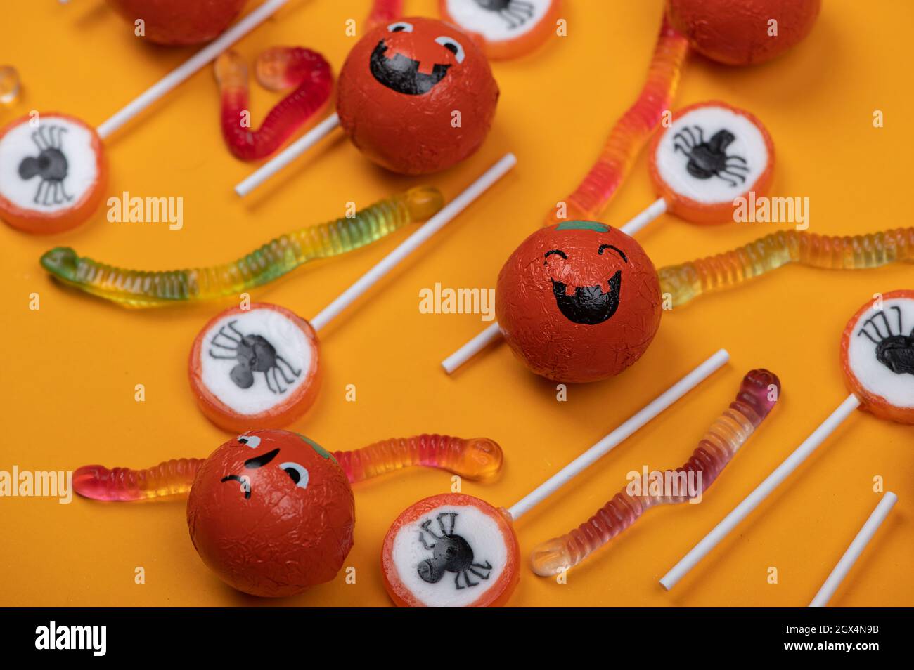 Halloween candy with black spiders,cobweb,smiling pumpkins and tasty ...