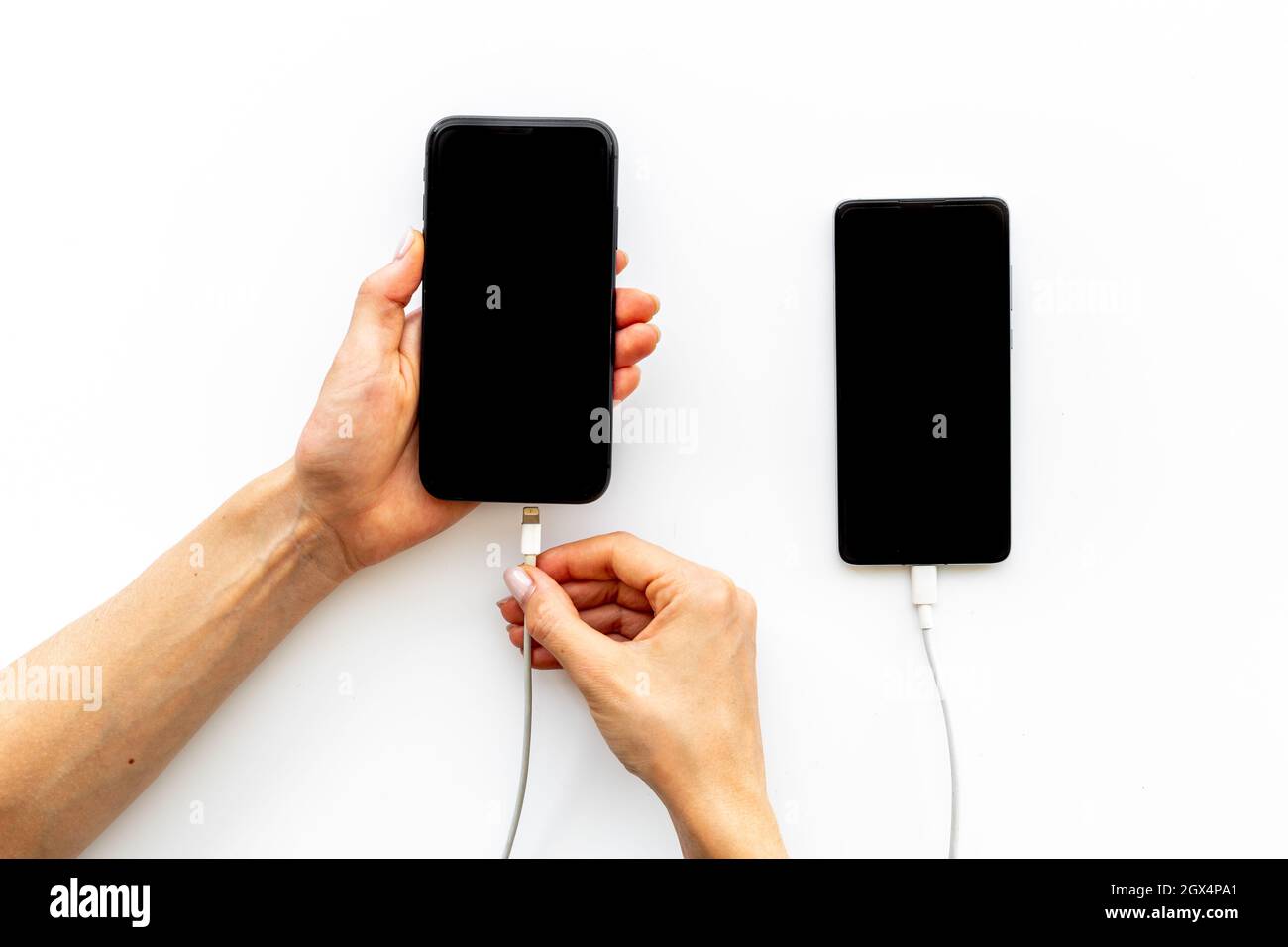 Hands plugging charger in mobile phone. Charging cable for smartphone ...