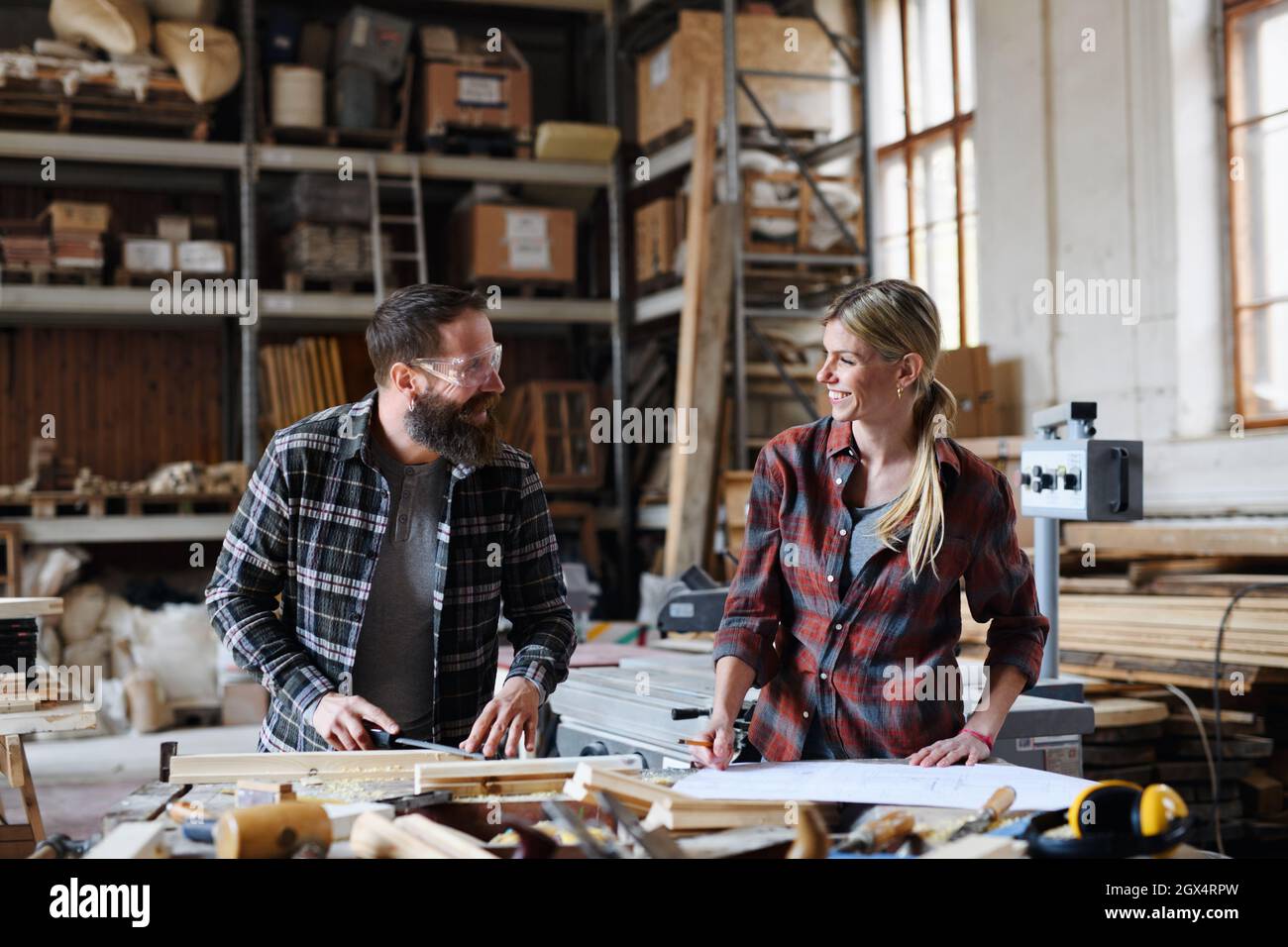 Two carpenters man and woman talking about design of products. Small ...