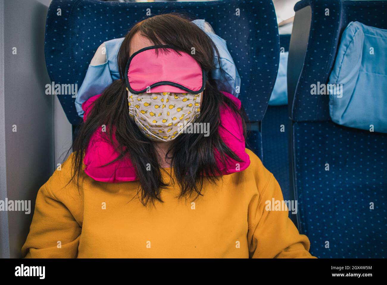 Young unknown woman with black hair is resting on a modern train ...