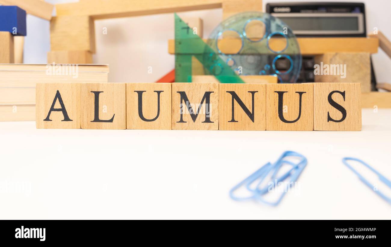 The word Alumnus was created from wooden cubes. close up Stock Photo ...
