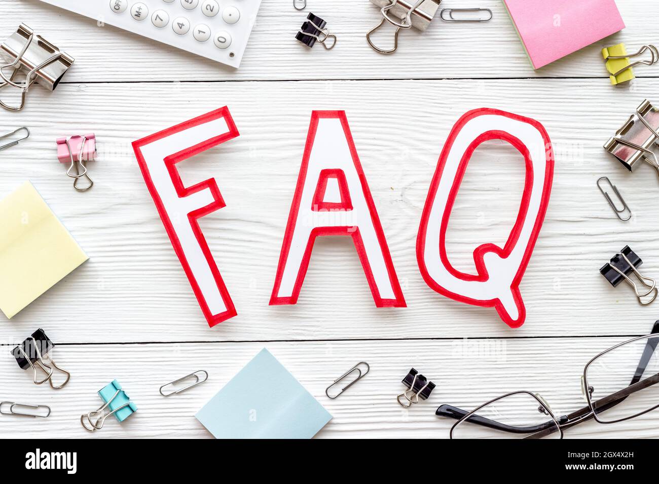 Text faq frequently asked questions on office table with stationery ...