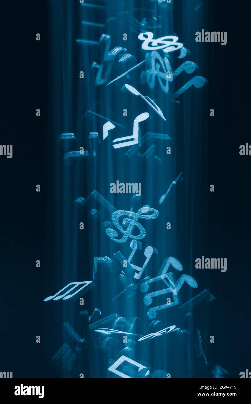 Musical notes fall in a stream of light. Tinted image Stock Photo - Alamy
