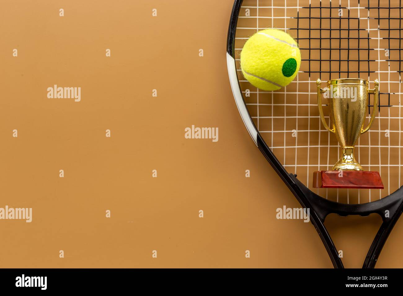 Tennis champion award - small golden trophy cup with tennis racket and ...