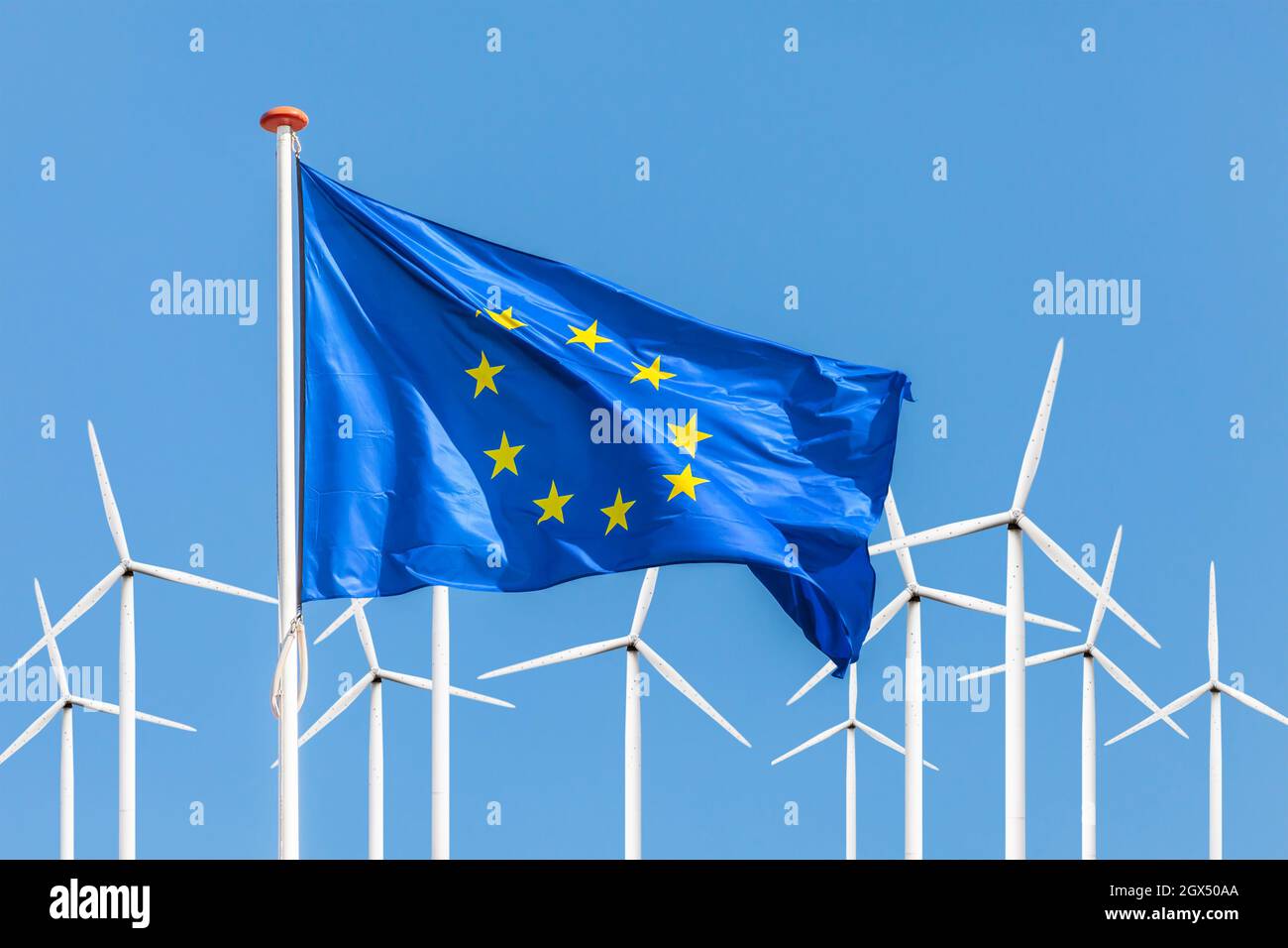 Official flag of the European Union in front of a large windpark with ...
