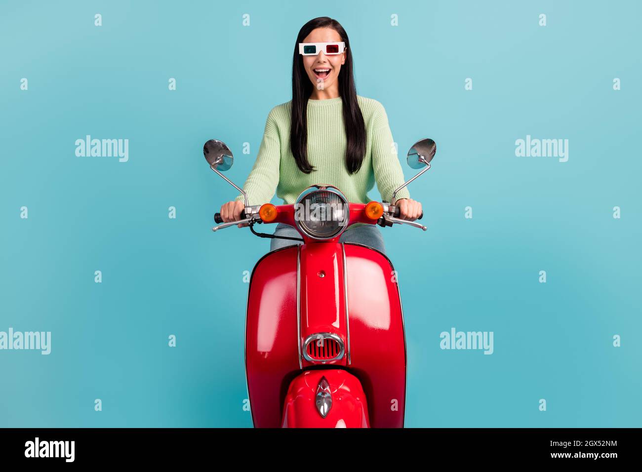 Portrtait of attractive cheerful cool funky girl riding moped wearing ...