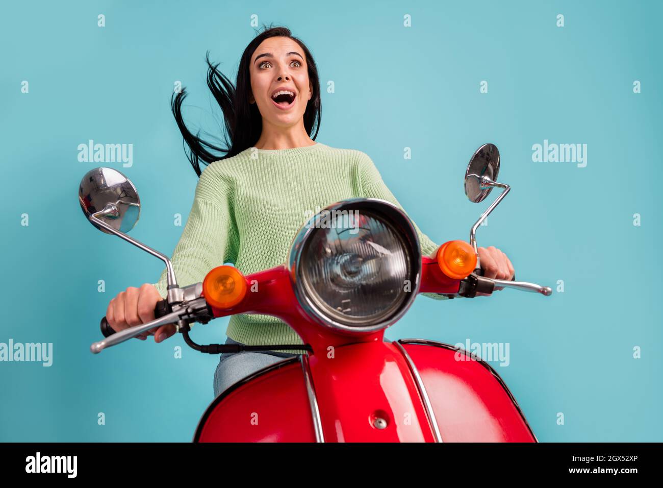 Photo of astonished positive person driving bike hurry open mouth have ...