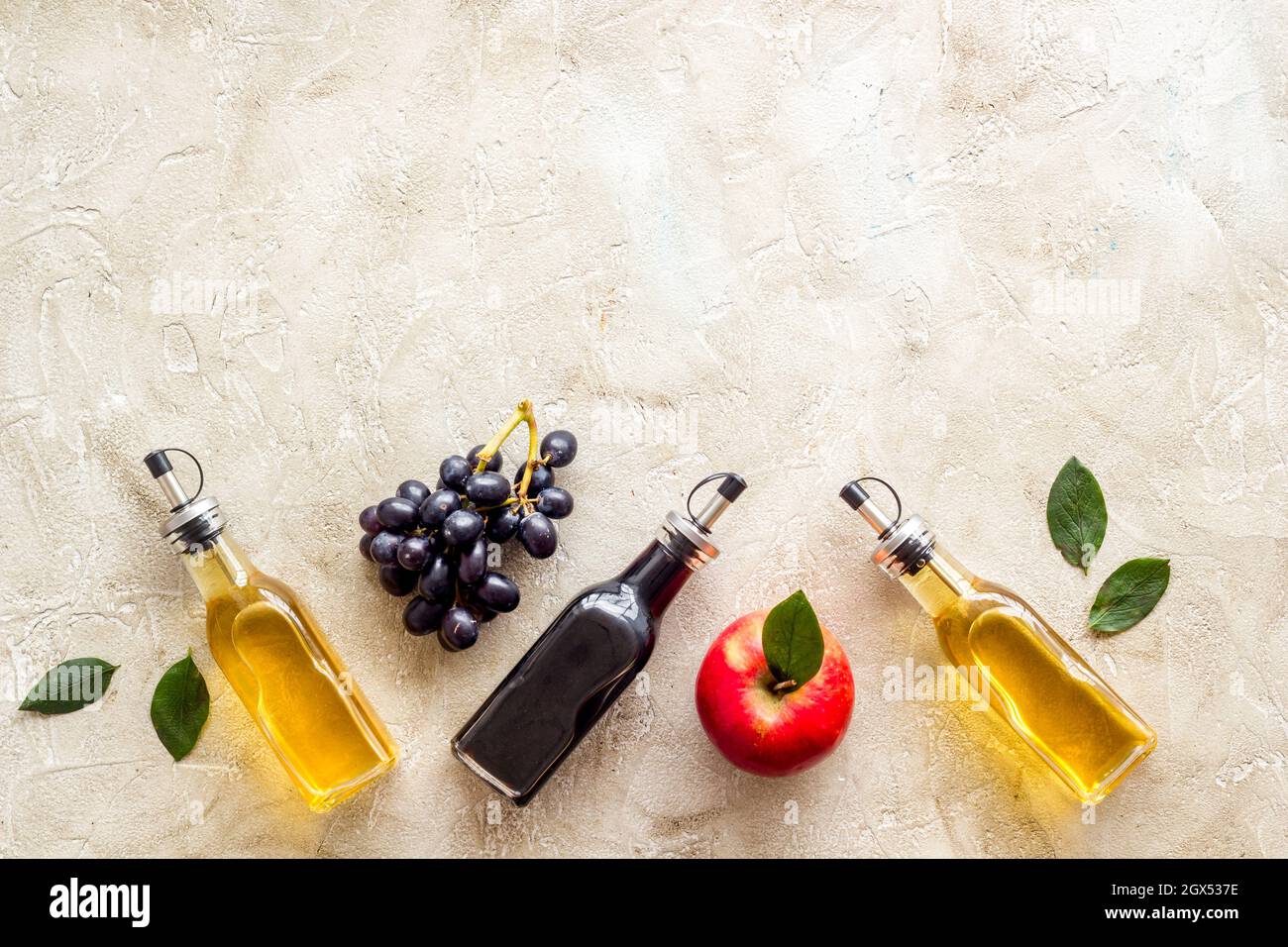 Red wine and apple cider vinegar with grapes and red apples Stock Photo ...