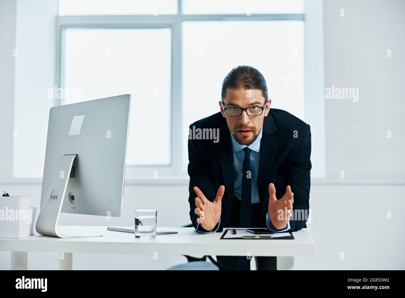 The man in a suit in the office gestures with his hands boss Stock ...