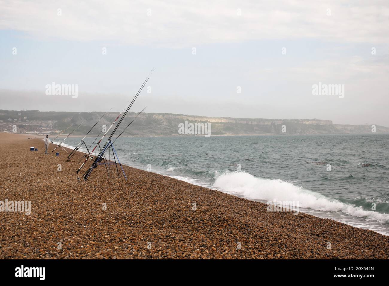 Fishing rods on a pebble beach Stock Photo - Alamy