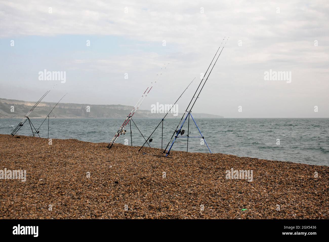 Fishing rods on a pebble beach Stock Photo - Alamy