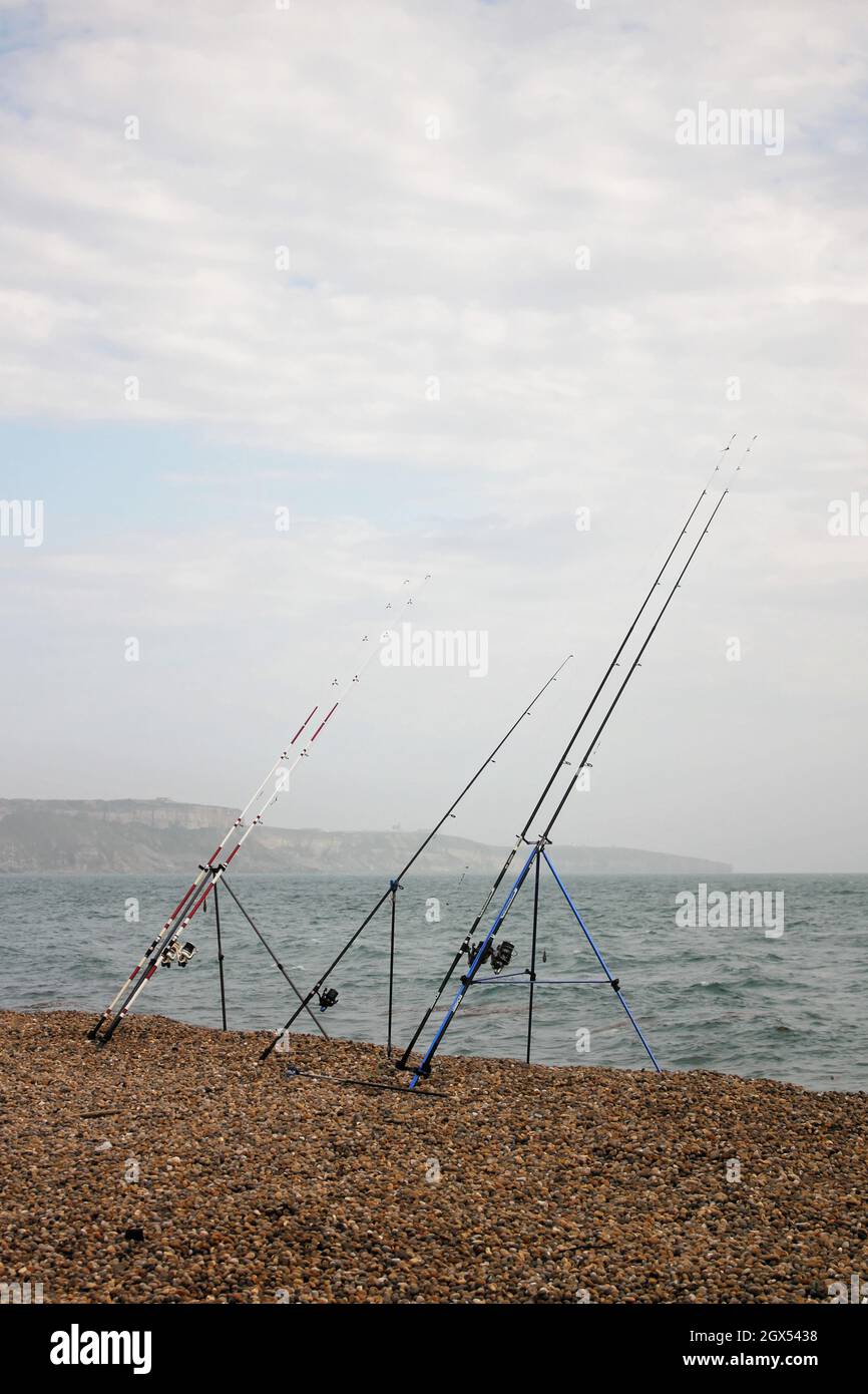Fishing rods on a pebble beach Stock Photo - Alamy
