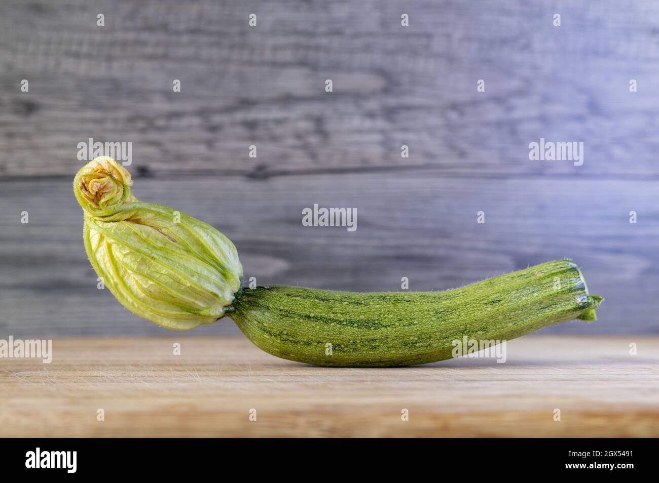 Closeup of the zucchini, courgette on the wooden table Stock Photo - Alamy