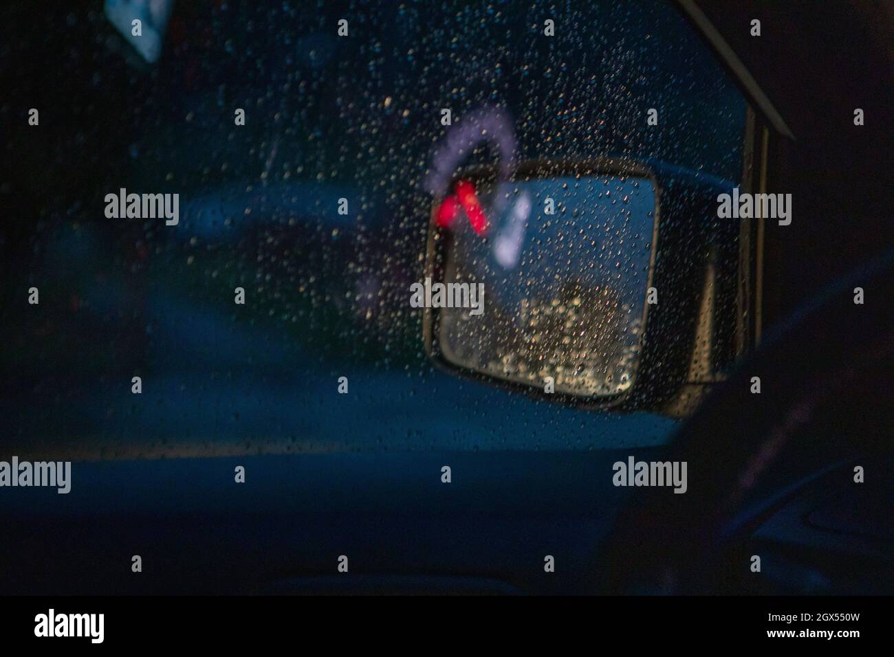 night car driving rain drops on window side mirror Stock Photo - Alamy
