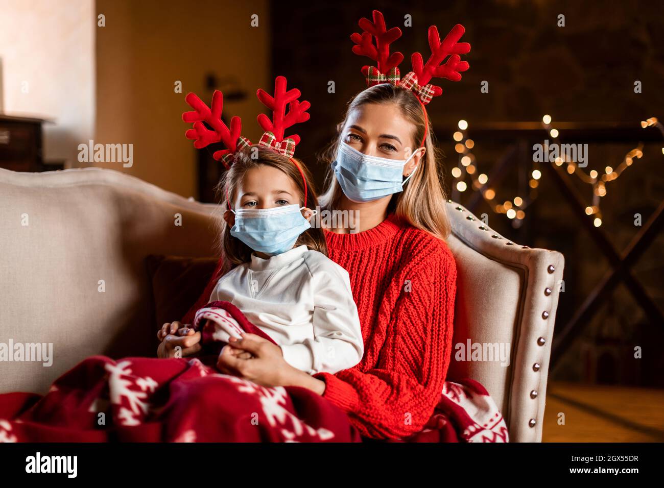 Portrait of happy loving family in face mask celebrating xmas Stock ...