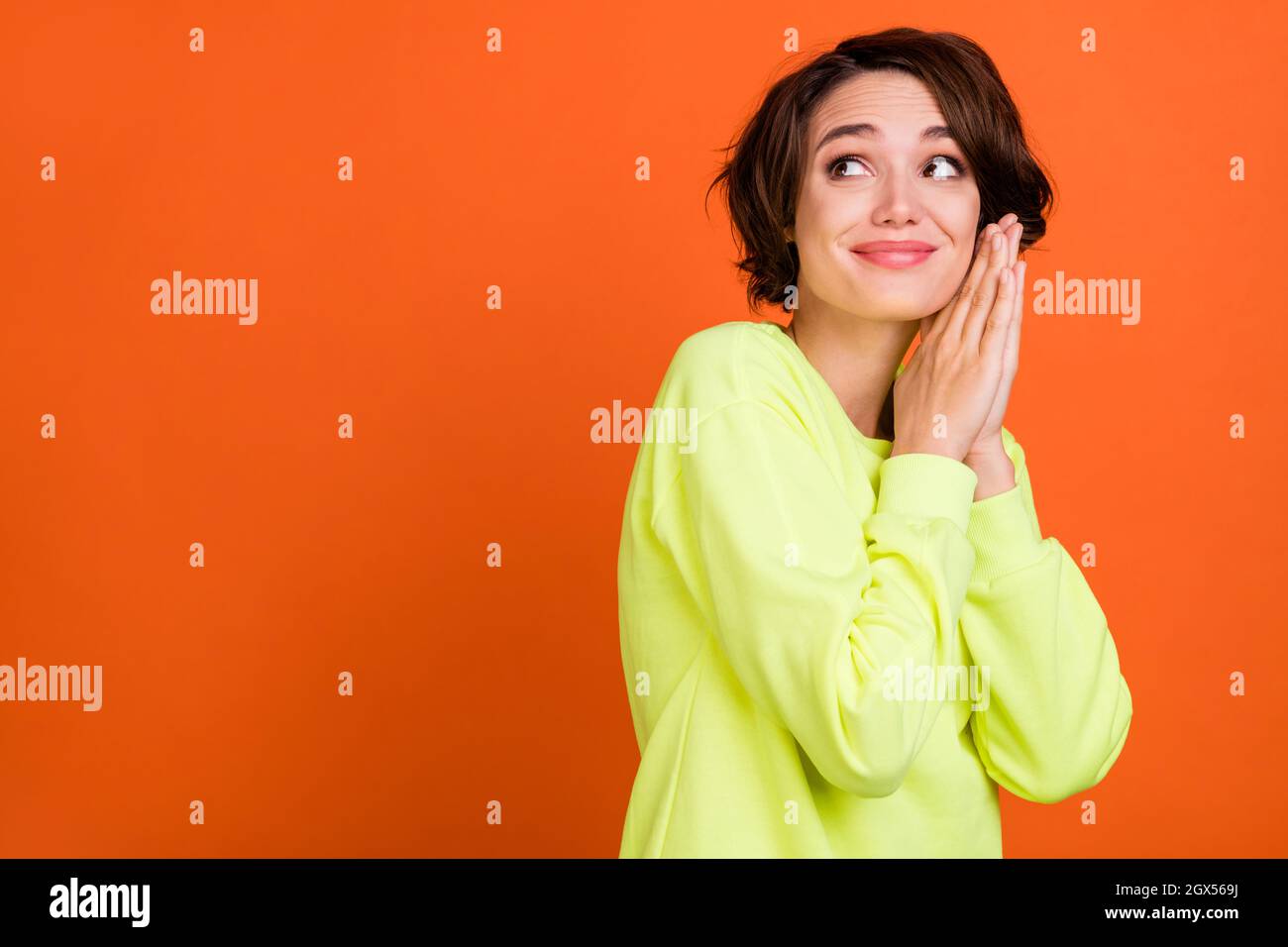 Photo of cheerful young positive dreamy woman look empty space pray ...
