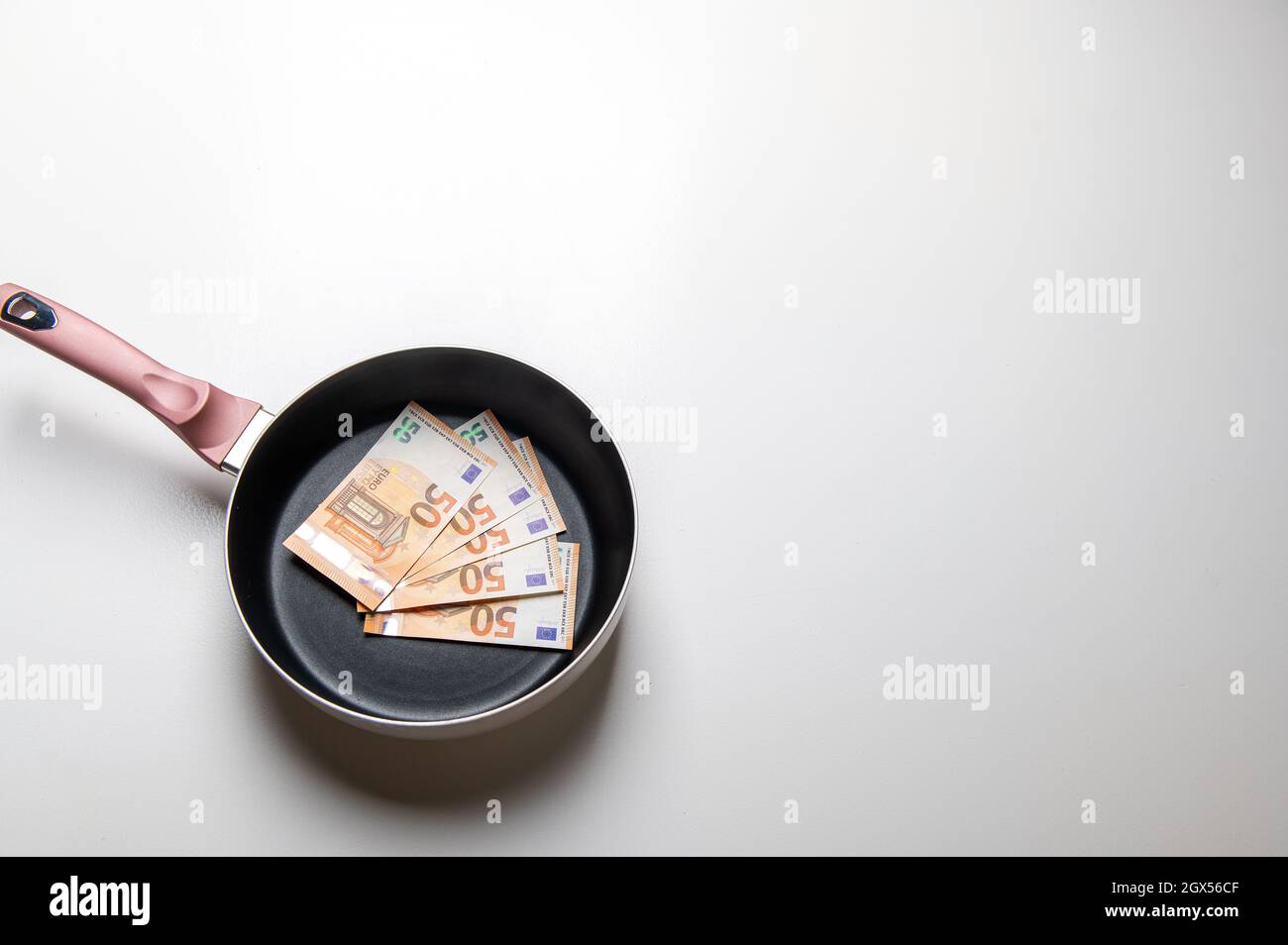 New frying pan with money euro banknotes on a white background Stock ...