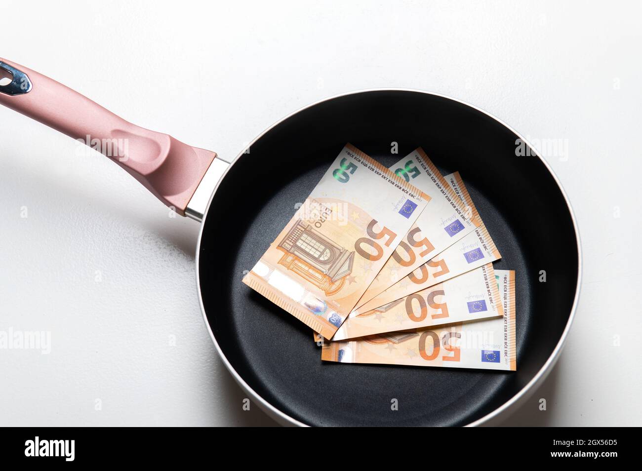 New frying pan with money euro banknotes on a white background Stock ...