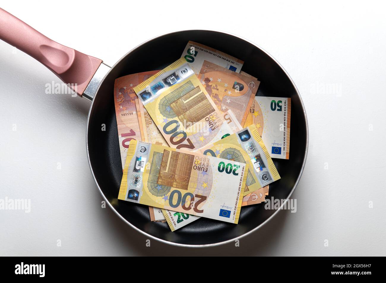 New frying pan with money euro banknotes on a white background Stock ...