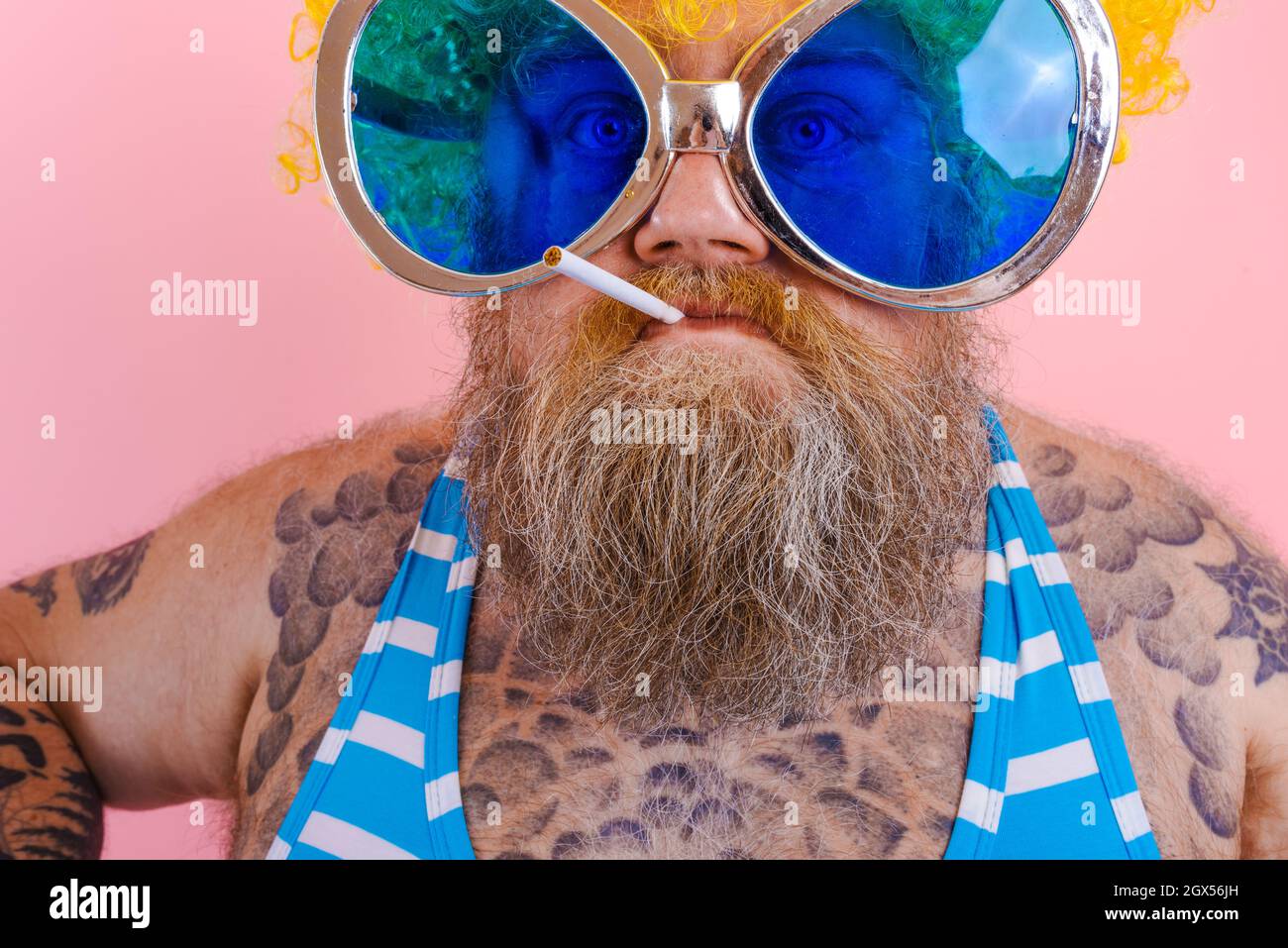 Fat angry man with beard and wig smokes cigarettes Stock Photo - Alamy