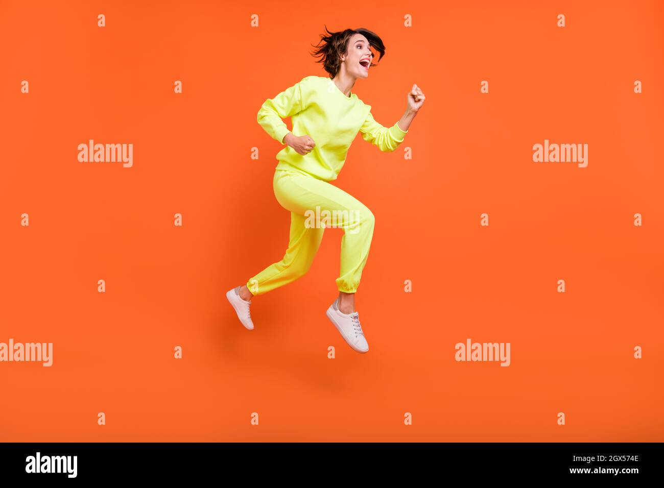 Full length body size view of attractive cheerful girl jumping running ...