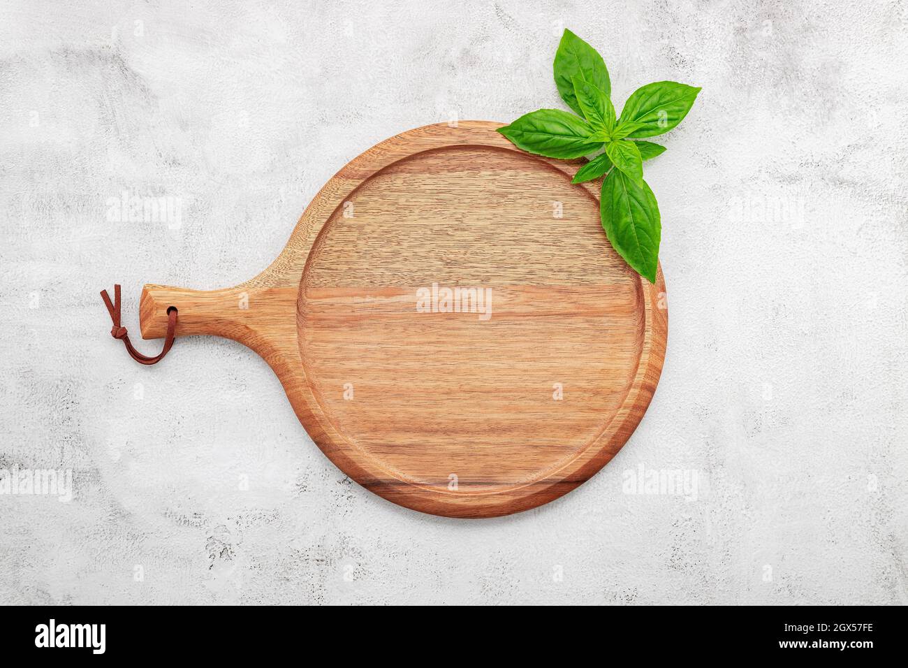 Empty wooden pizza platter set up on white concrete. Pizza tray on ...