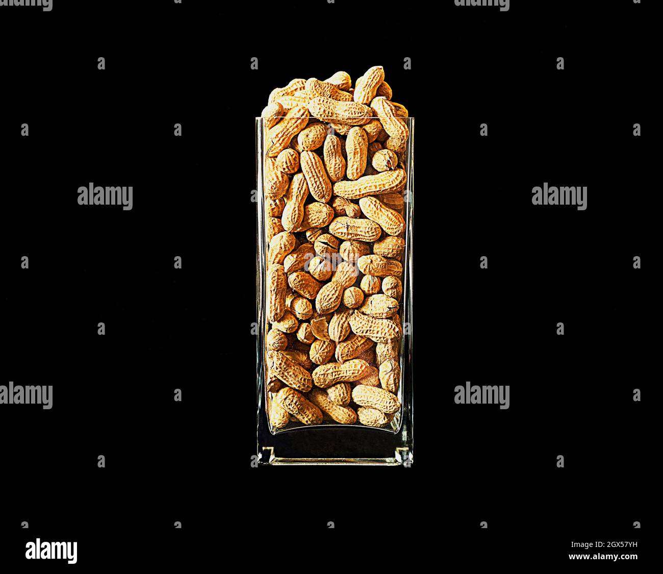 Closeup of peanuts in a jar on a black background Stock Photo - Alamy