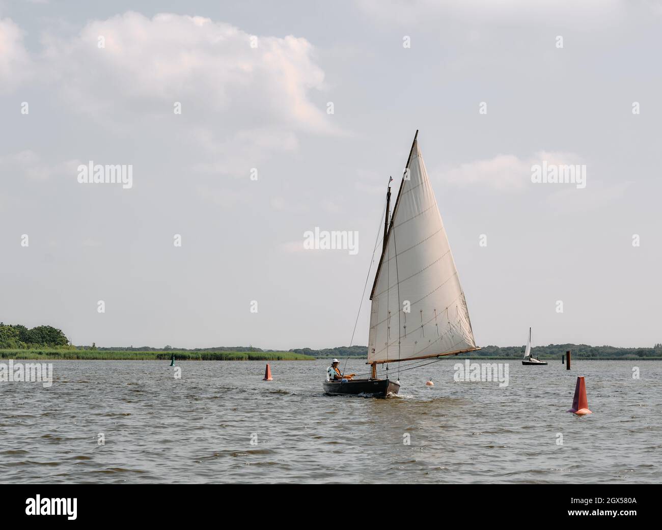 Sailing a traditional wooden sailing dinghy with a Gunter rig on ...