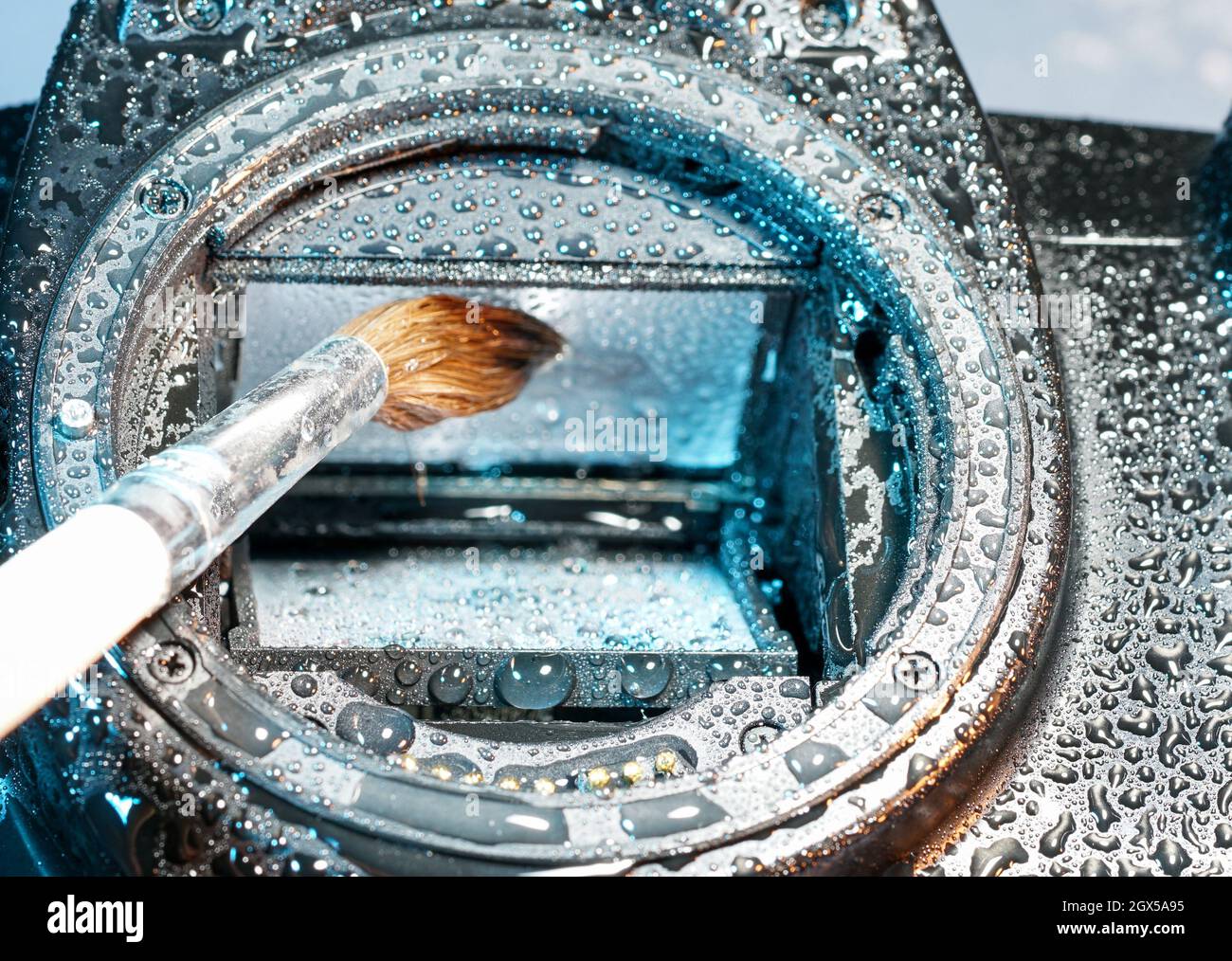 Close up shot on a drawing brush cleaning inside the lens glass in the ...